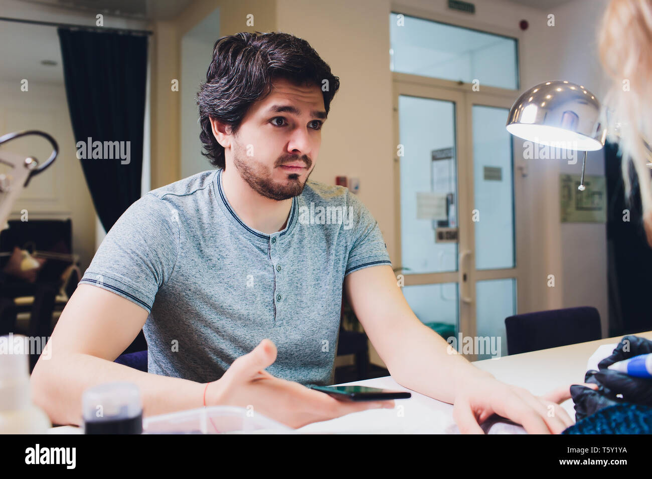 Hands in gloves cares about man's hand nails. Manicure beauty salon ...