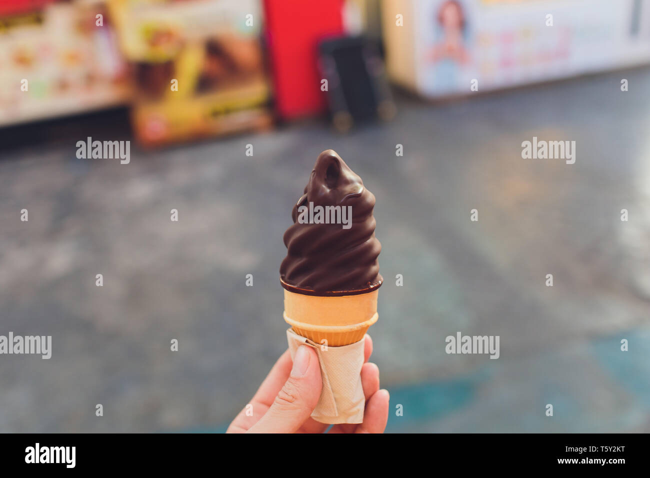 Hand holding chocolate triple scoop ice cream Stock Photo - Alamy