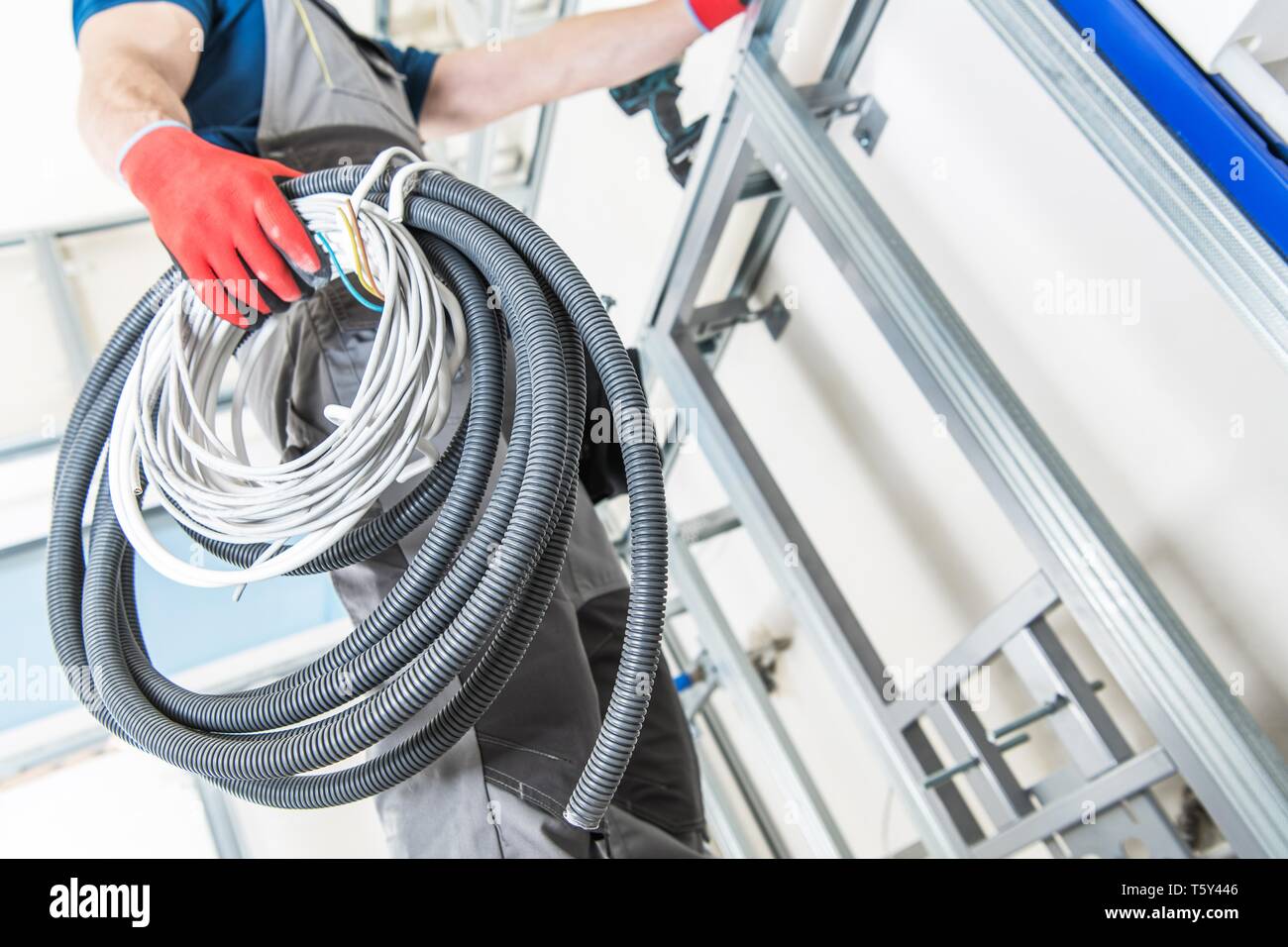 Construction Worker Preparing Electrical System Installation Inside the ...