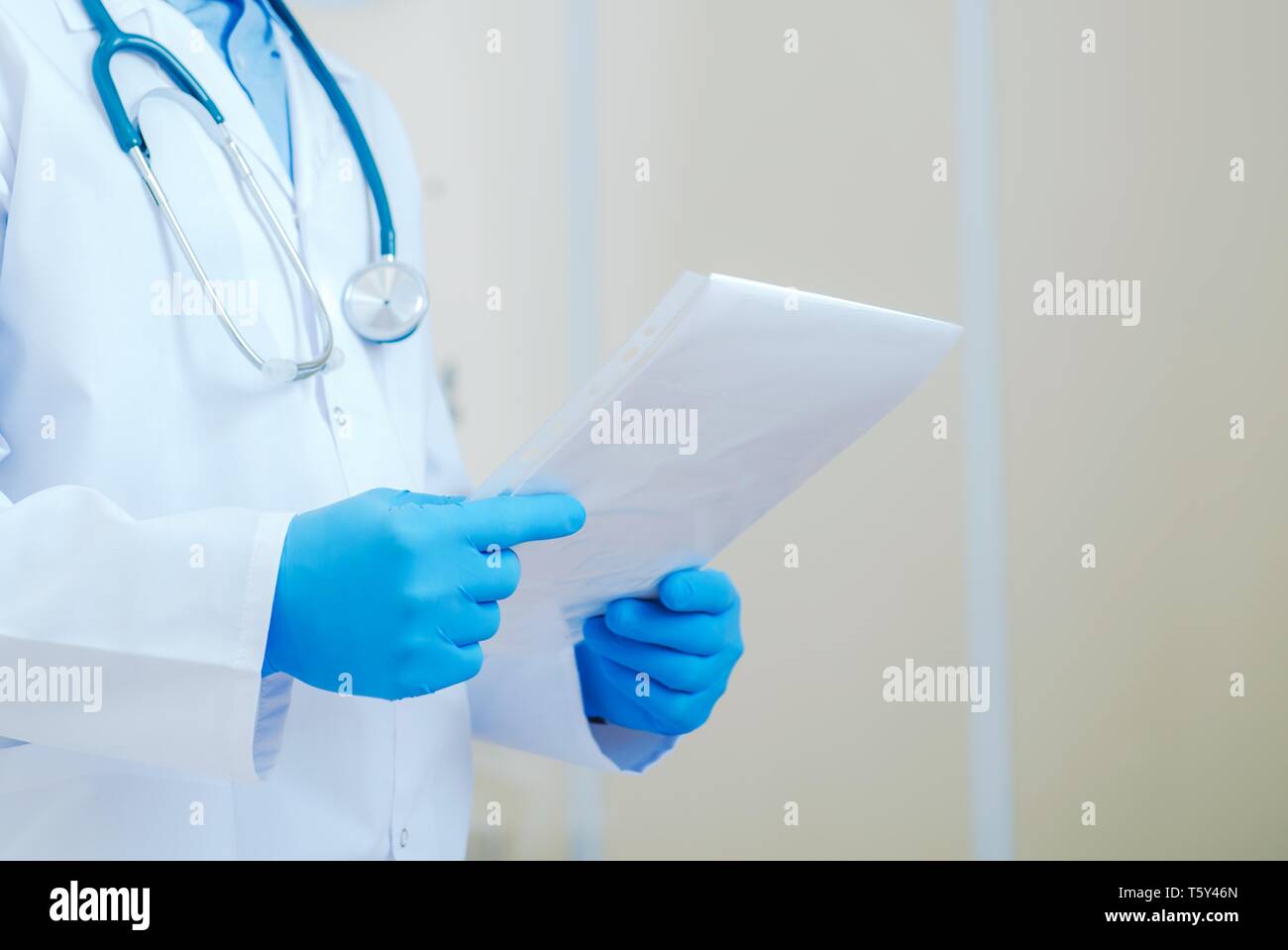 Doctor Wearing Blue Latex Gloves with Medical Documentation. Healthcare ...