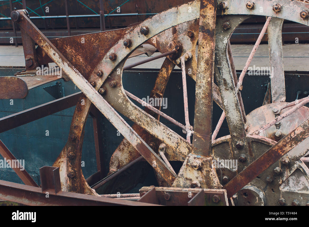 a small abandoned rusty metal wheel old Stock Photo - Alamy