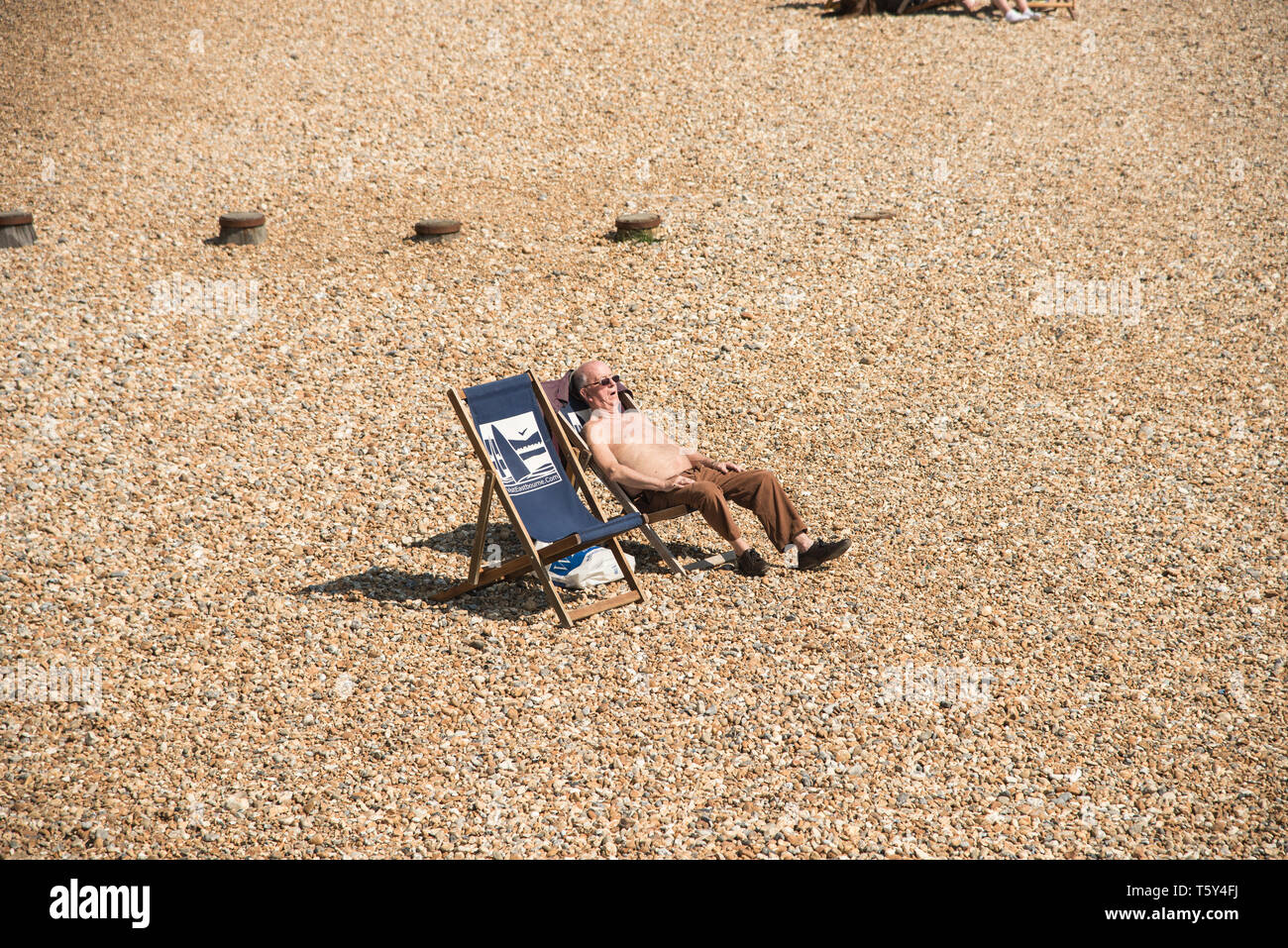 Old man sunbathing on beach hi-res stock photography and images - Alamy