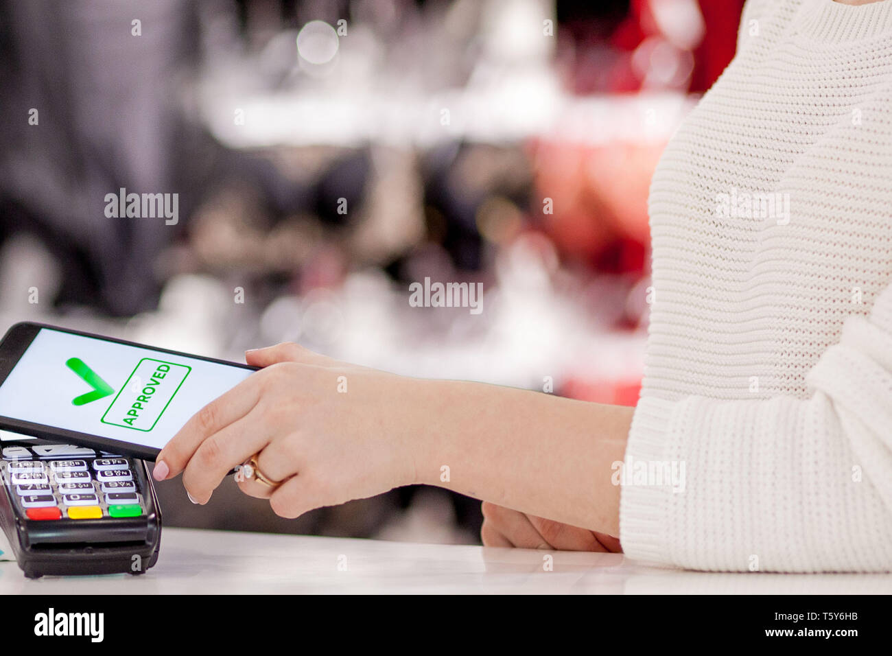 POS terminal, Payment Machine with mobile phone on store background ...