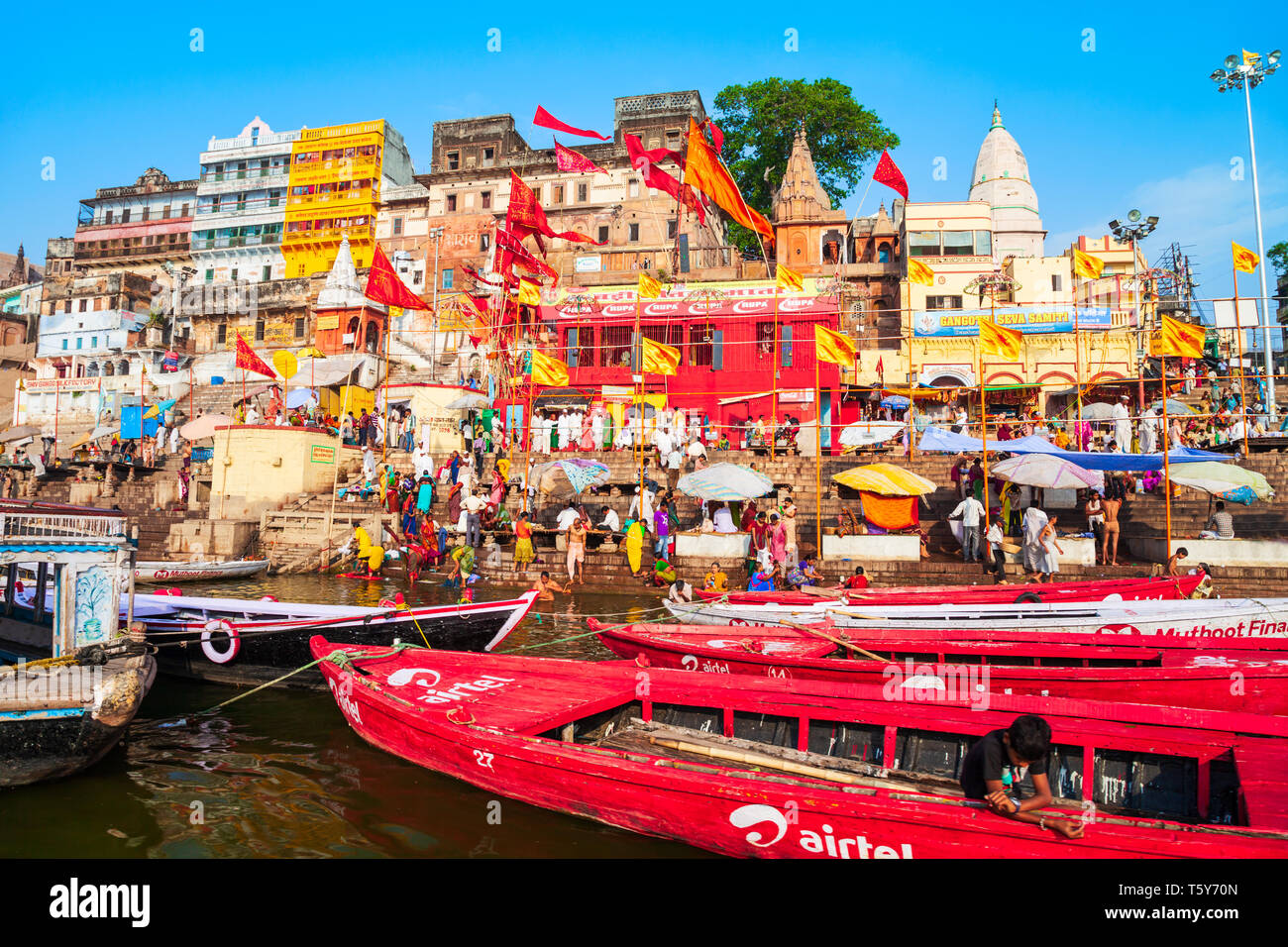 VARANASI, INDIA - APRIL 12, 2012: Colorful boats and Ganges river bank ...