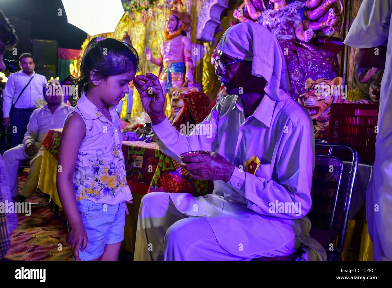 A priest seen applying tika to a kid during the ritual. Jagran is a ...