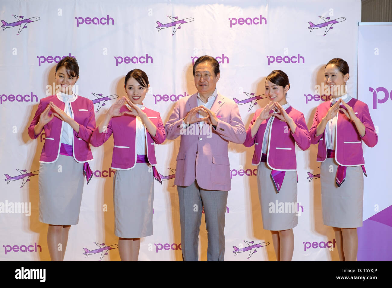 Mr. Shinichi Inoue, President and CEO of Peach and cabin crew are seen ...