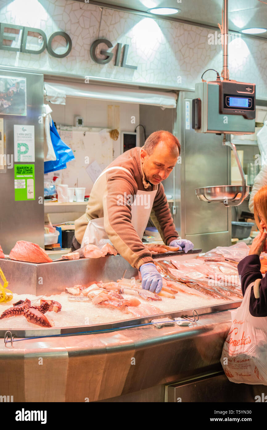 stallholder in Valencia's Central Market, Spain selling seafood and ...