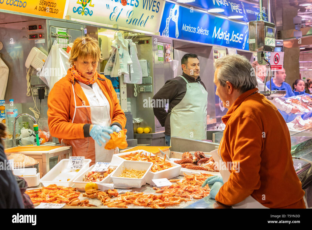 stallholder in Valencia's Central Market, Spain selling seafood and ...