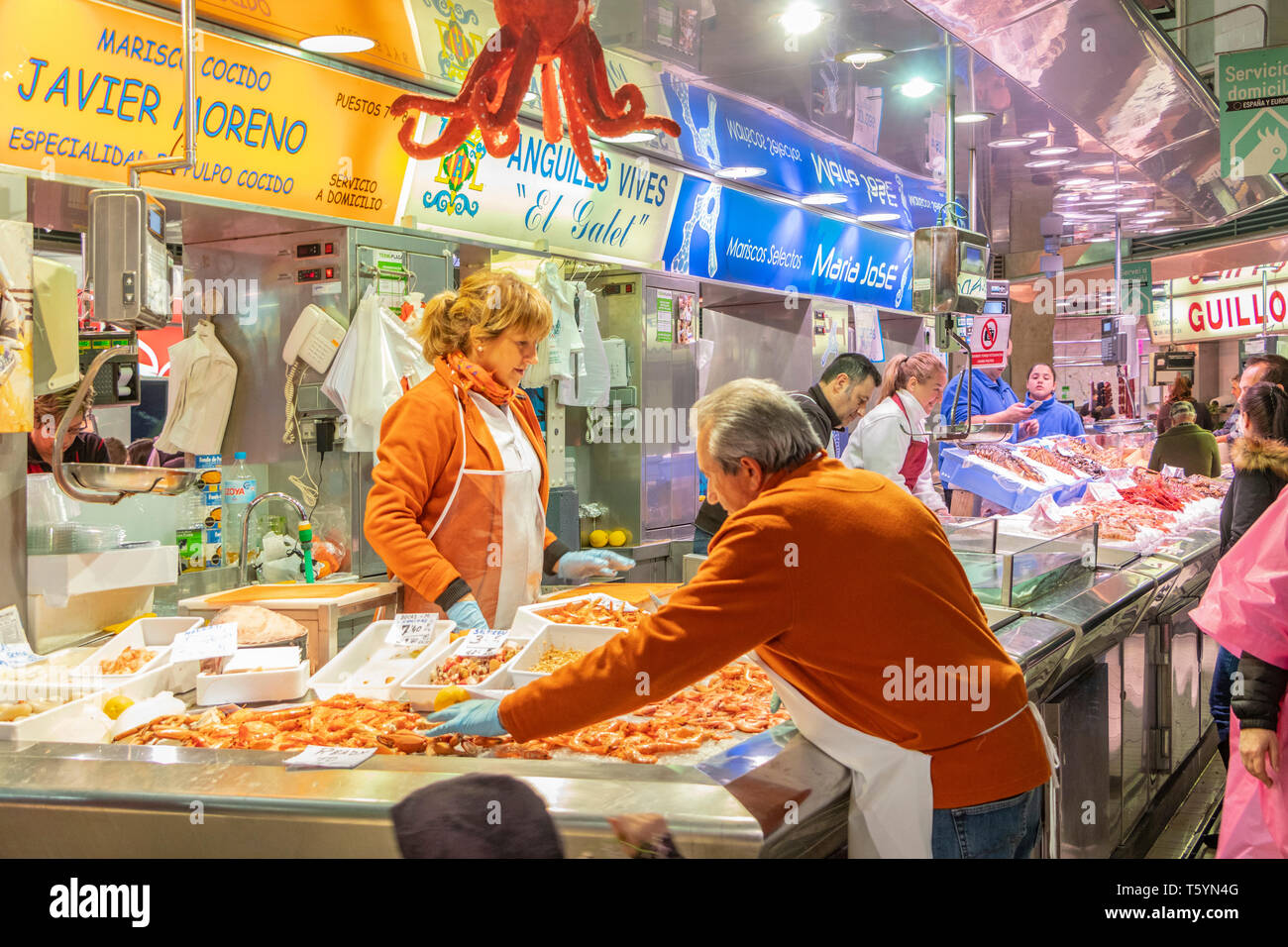 stallholder in Valencia's Central Market, Spain selling seafood and ...