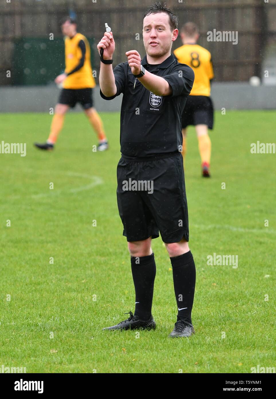 The referee gives instructions during the football match between New ...
