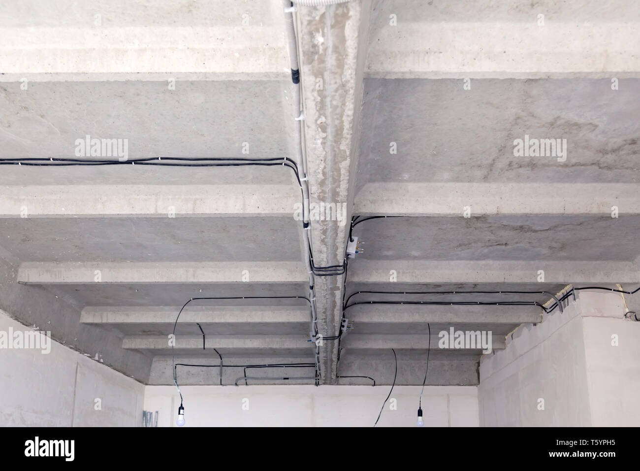Cable laying ceiling. Electrical wires on wall. Wiring replacement ...