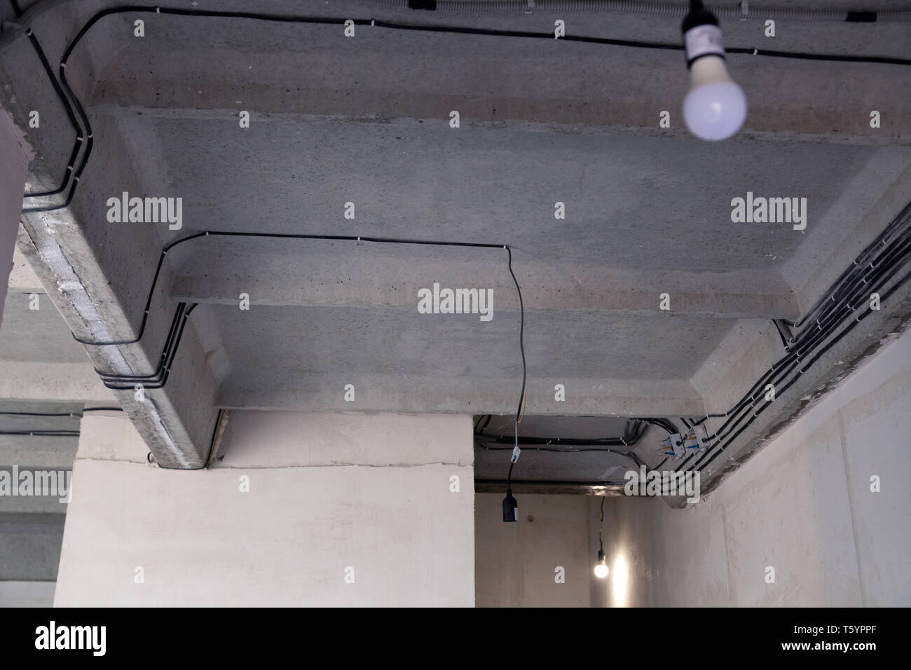 Cable laying ceiling. Electrical wires on wall. Wiring replacement ...