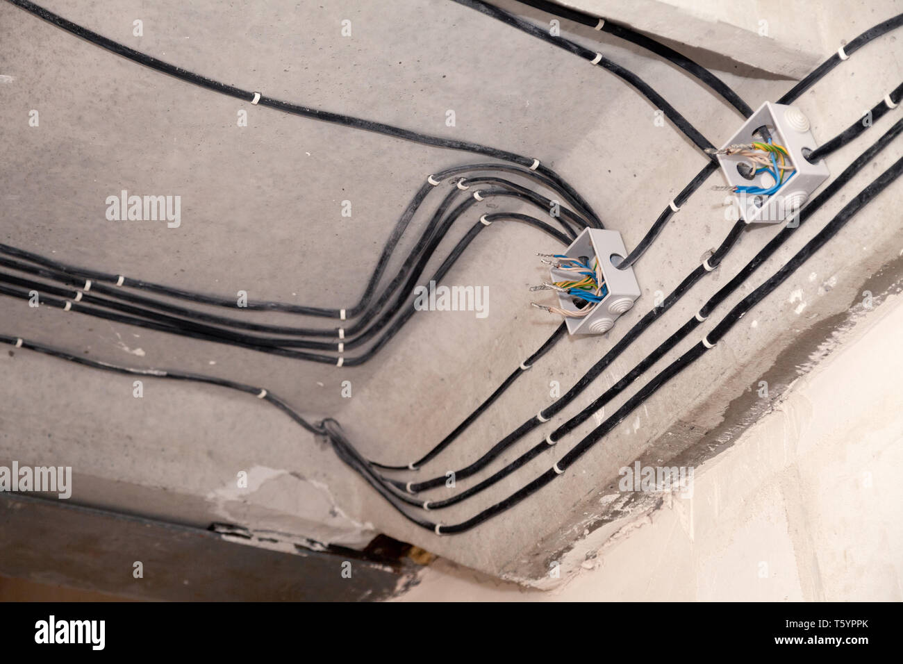 Cable laying ceiling. Electrical wires on wall. Wiring replacement ...