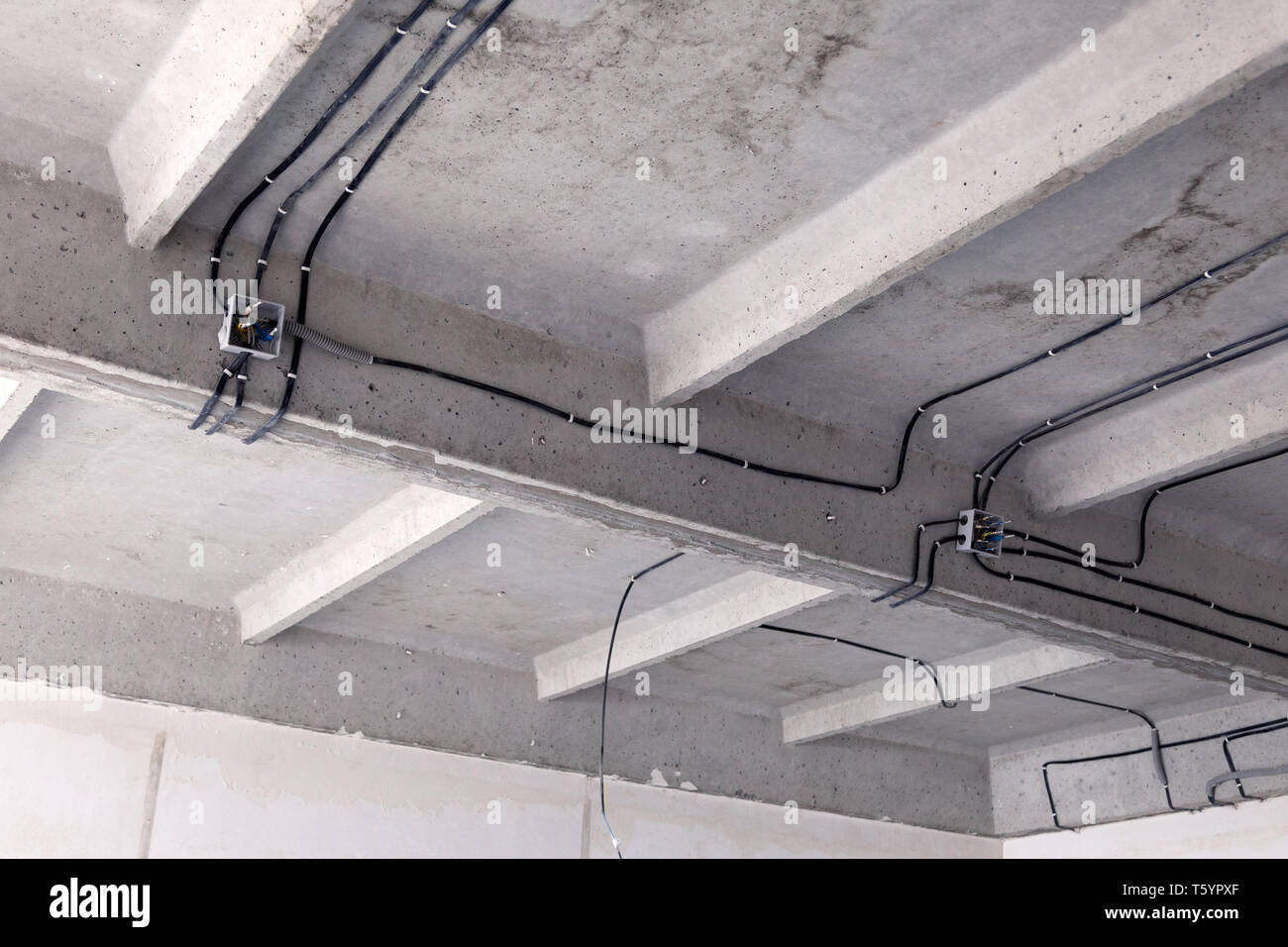 Cable laying ceiling. Electrical wires on wall. Wiring replacement ...