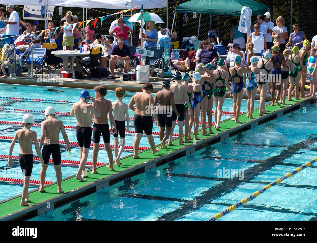 Elementary school boys and girls lining up for an outdoor pool for a ...