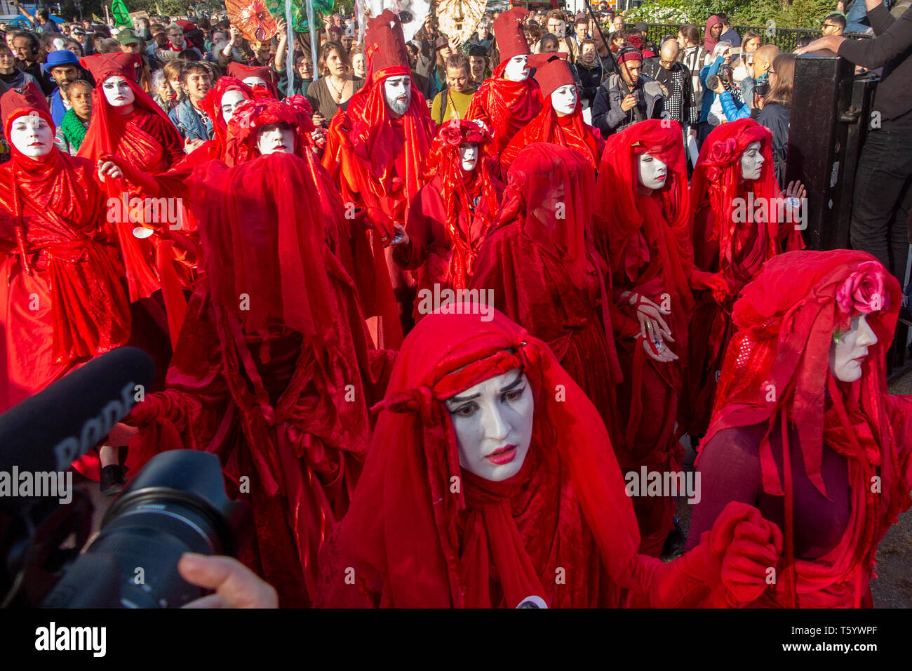 Red brigade environmental activists dressed as blood tears representing ...