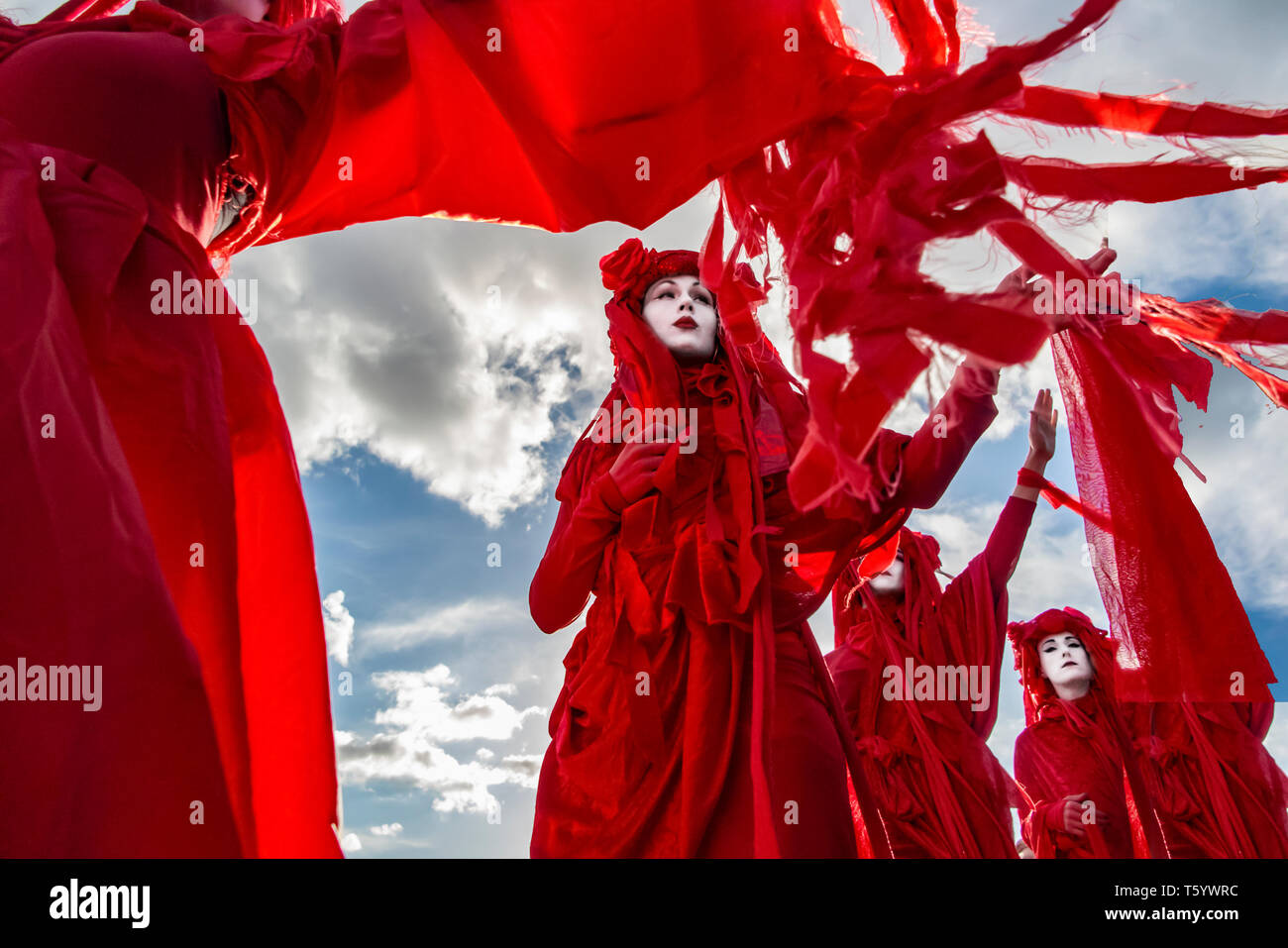 Red brigade environmental activists dressed as blood tears representing ...