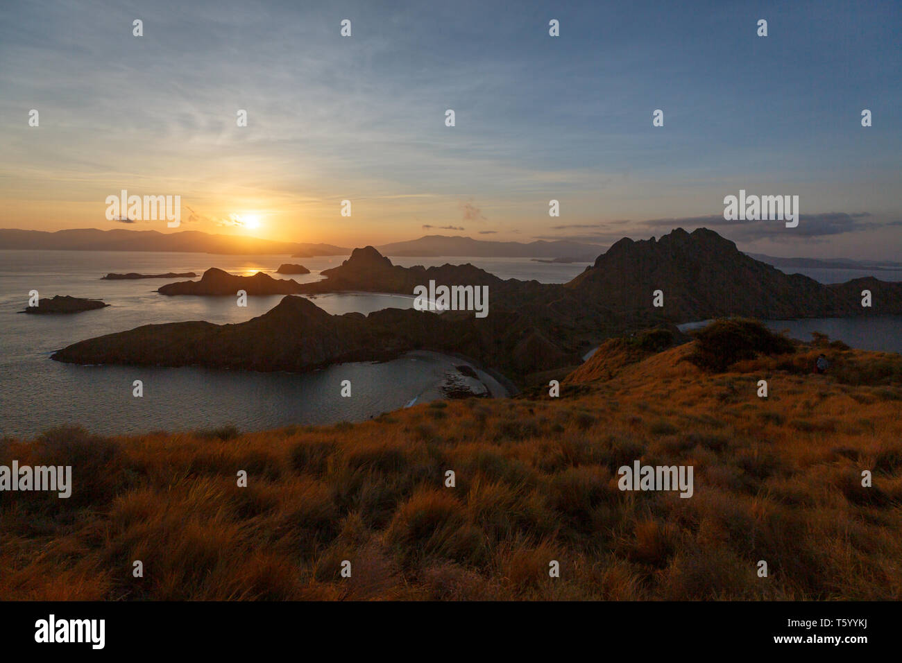 Sunset from hilltop on mountains in Komodo national park silhouettes ...