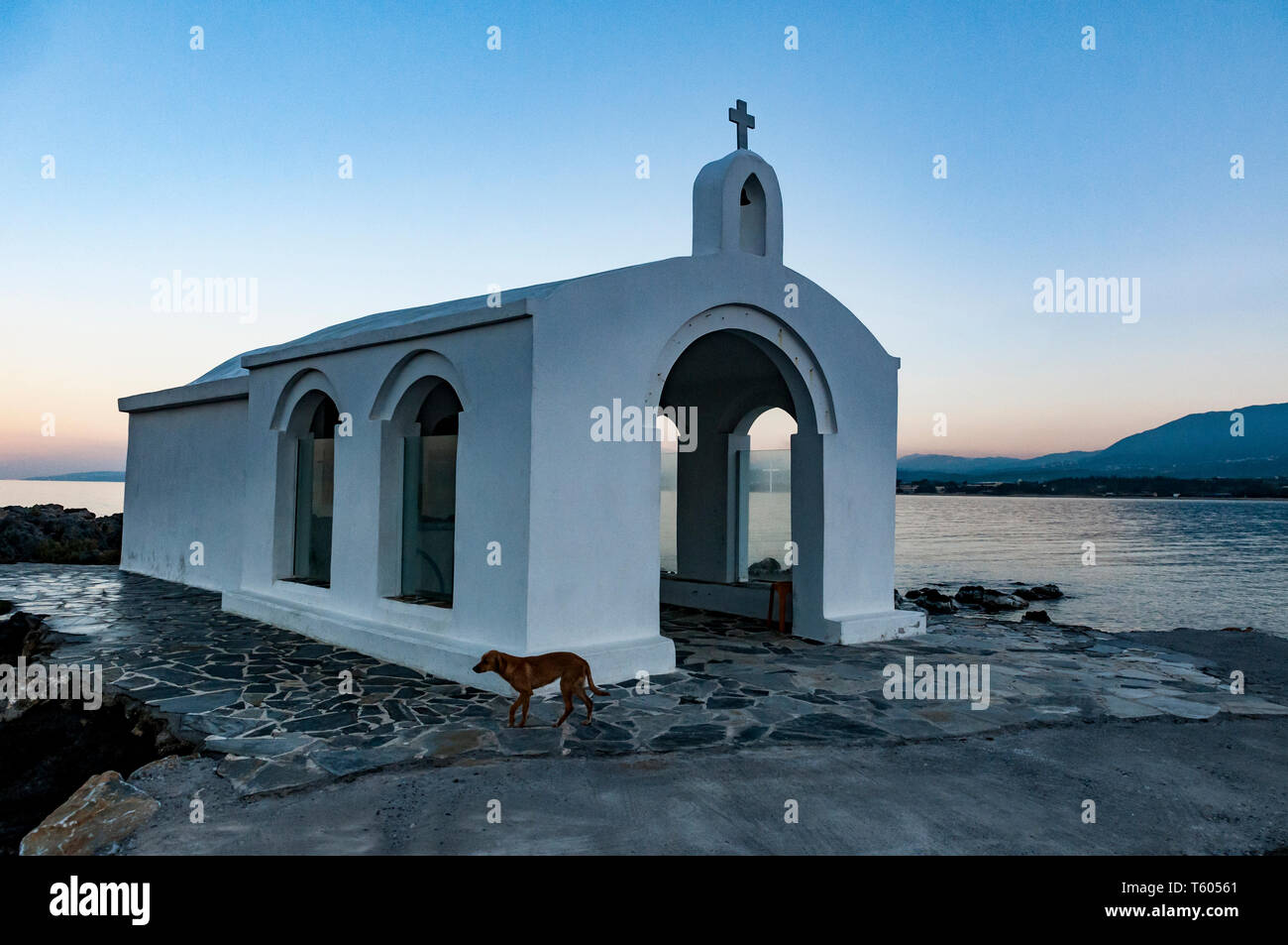 small white church beside sea in crete island Stock Photo - Alamy