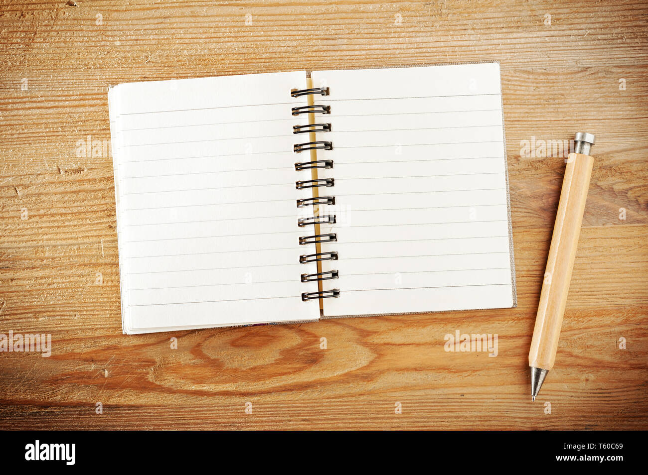 wooden desktop with blank notebook paper background, writing concept ...