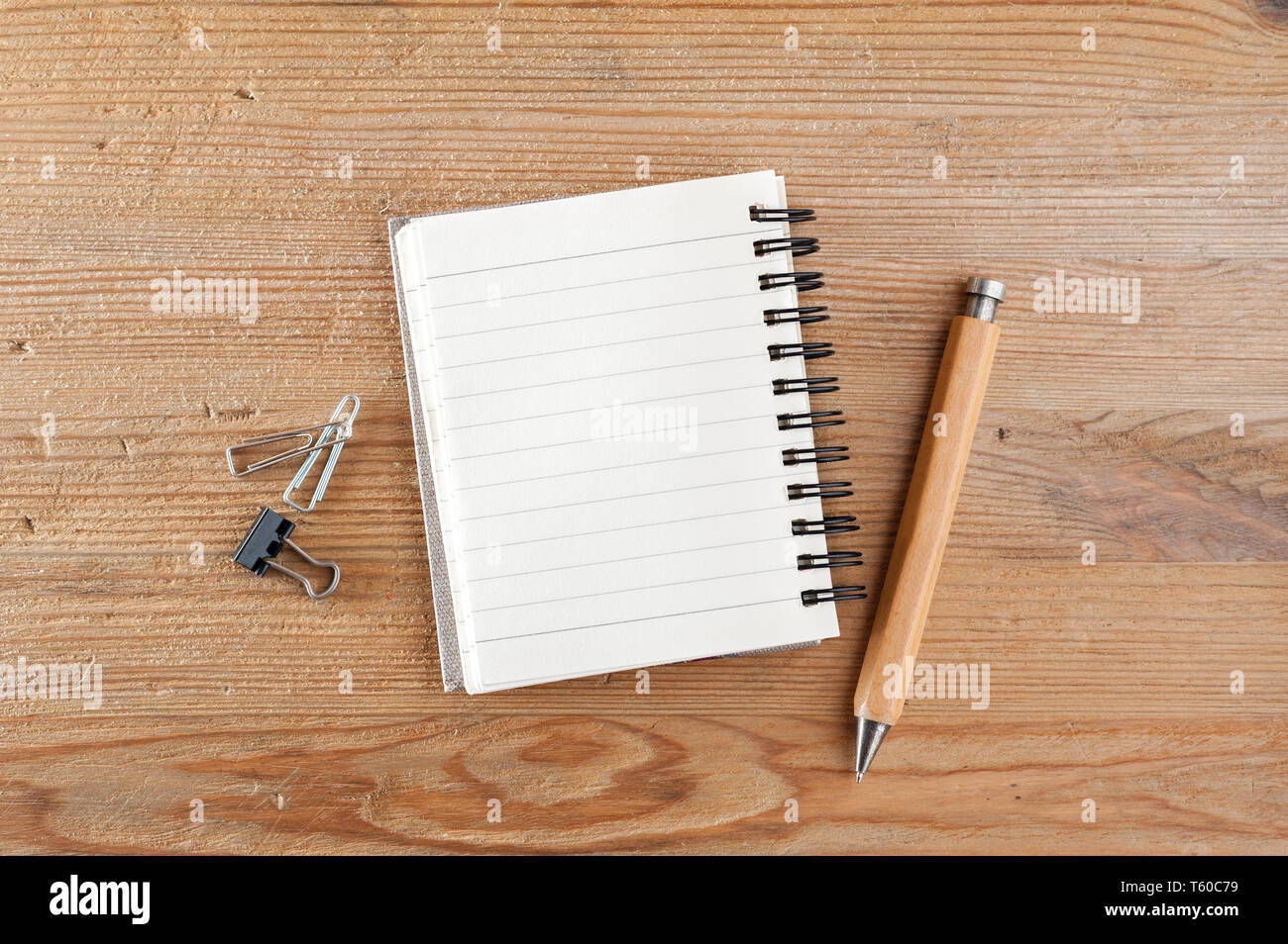 wooden desktop with blank notebook paper background, writing concept ...