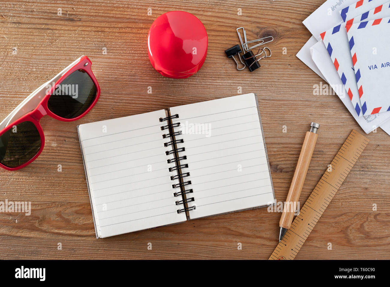wooden desktop with blank notebook paper background, writing concept ...