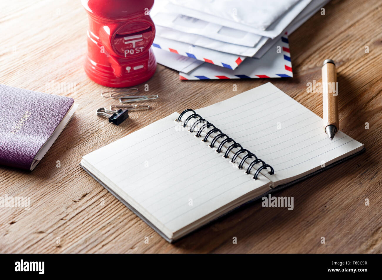wooden desktop with blank notebook paper background, writing concept ...