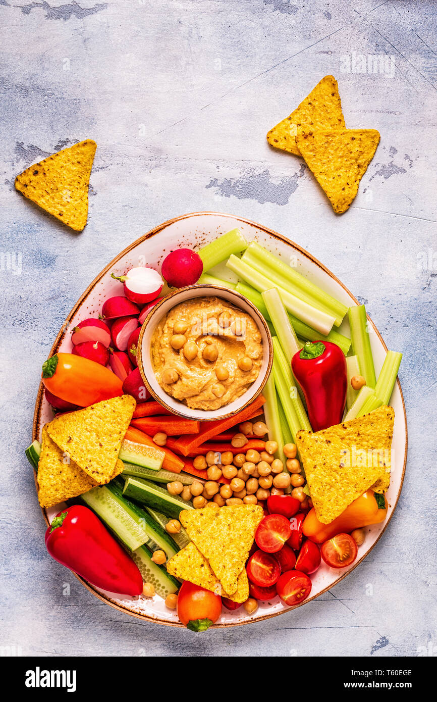 Hummus with various fresh raw vegetables, top view Stock Photo - Alamy