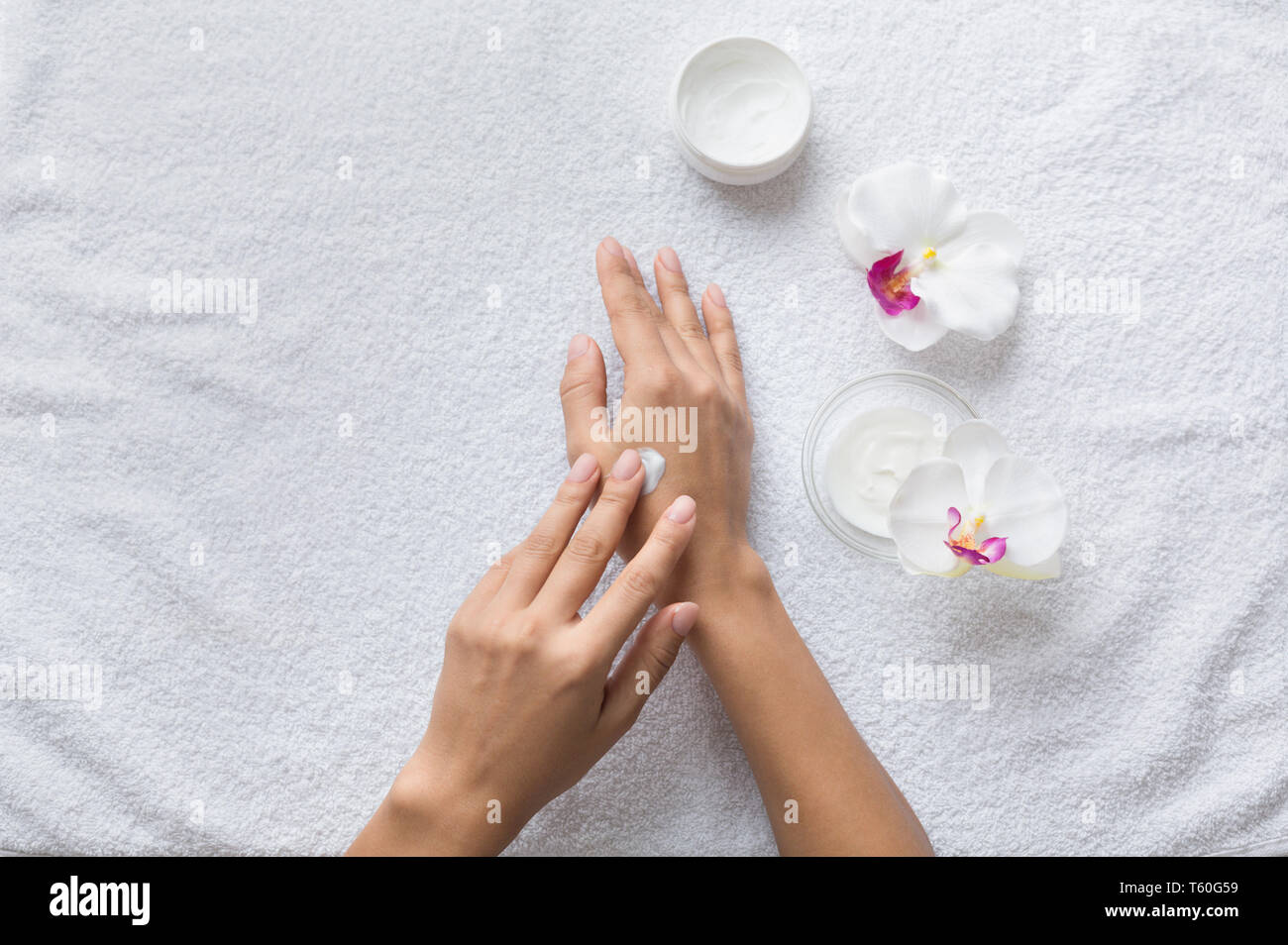 Skin nourishing concept. Woman putting cream on her hands Stock Photo ...