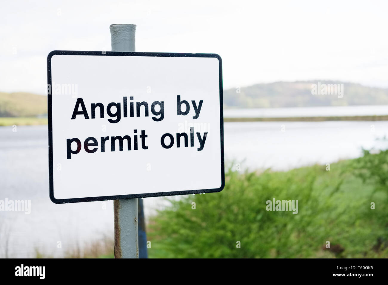 Angling by permit only sign at freshwater lake Stock Photo - Alamy