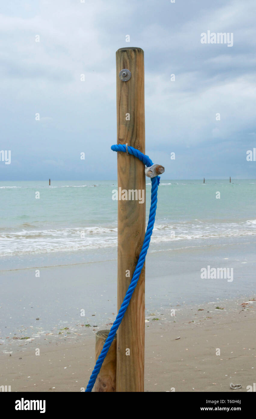 A blue rope twisted to a pole Stock Photo - Alamy
