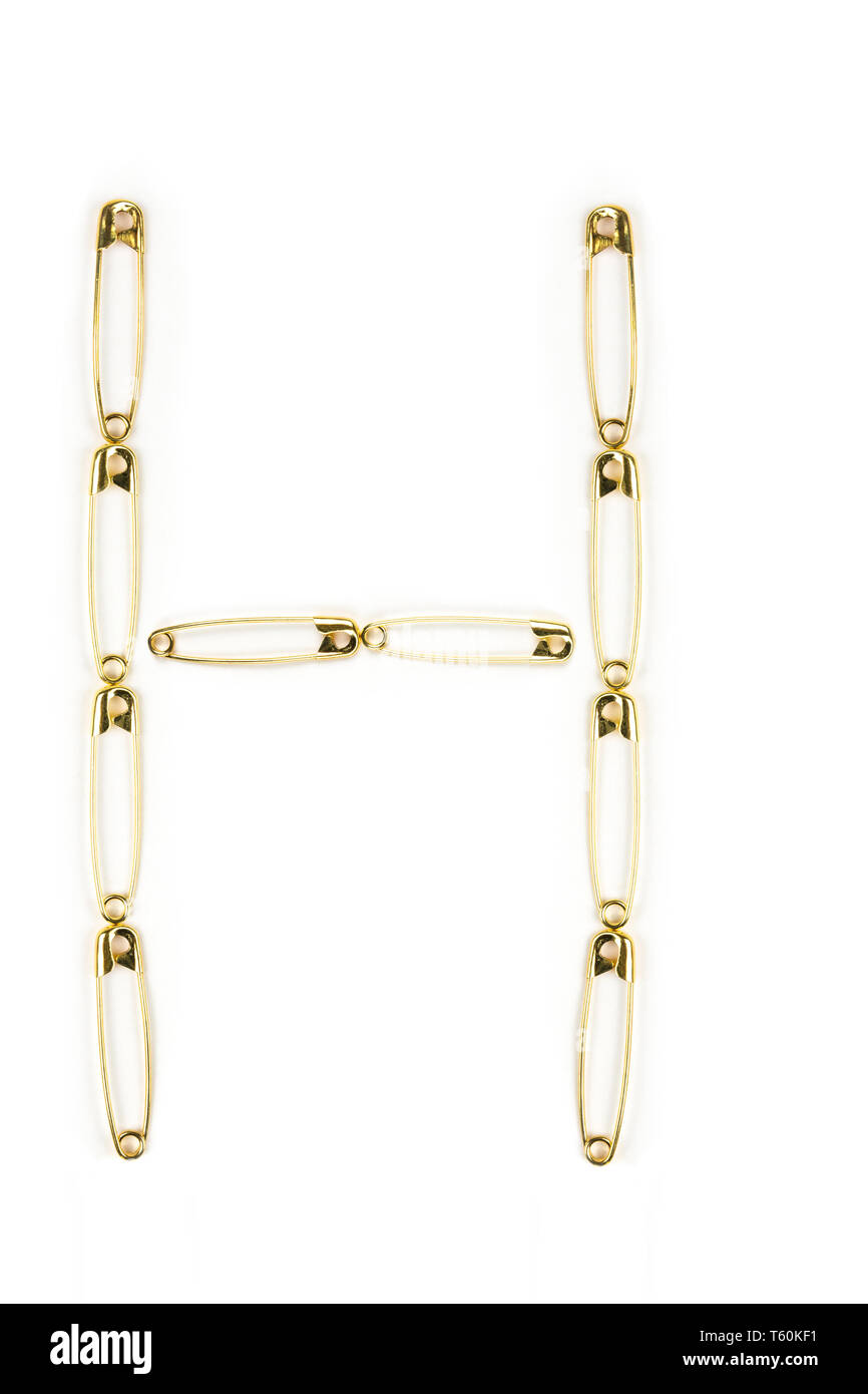 The letter "H" in gold colored safety pins Stock Photo - Alamy