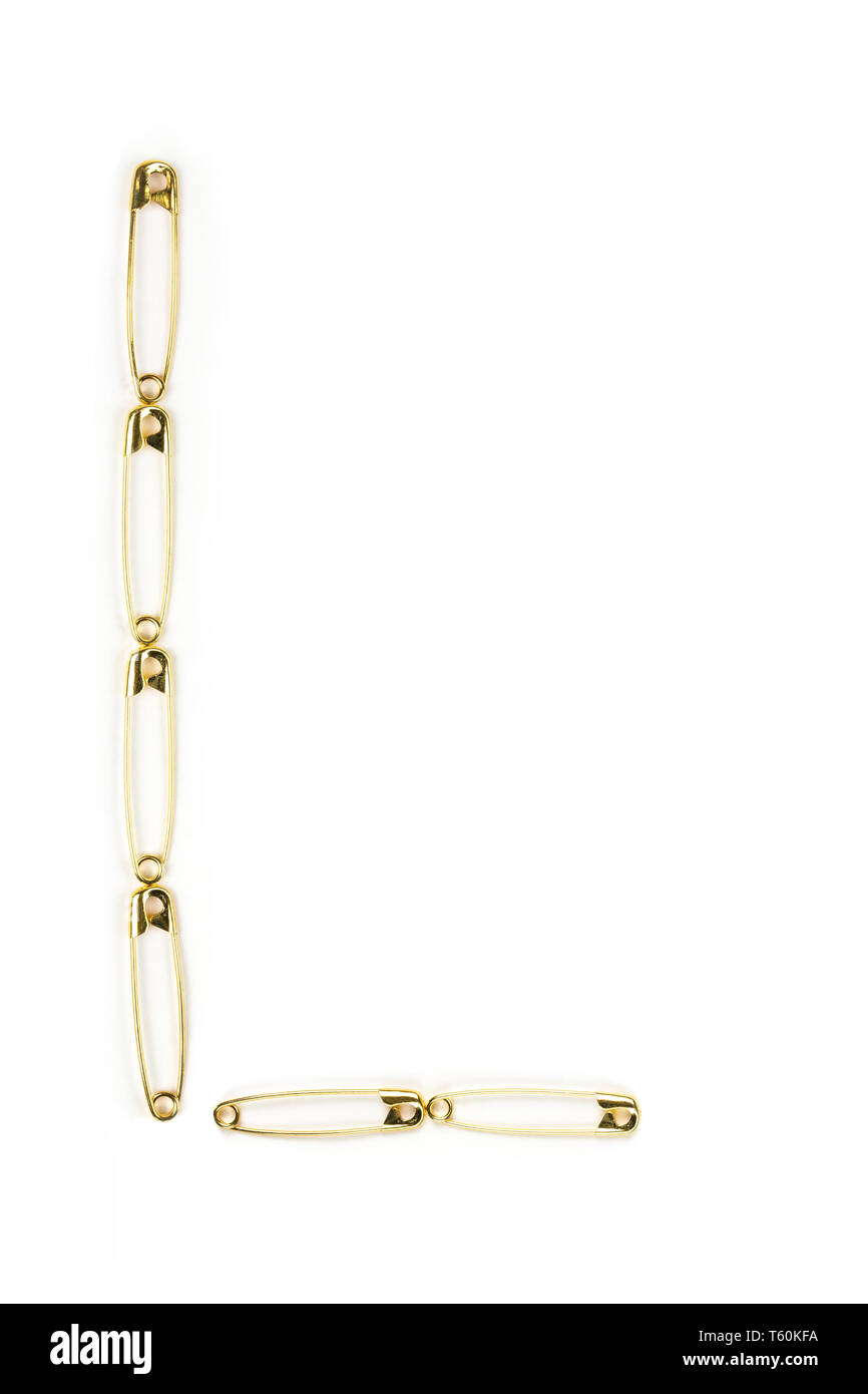 The letter "L" in gold colored safety pins Stock Photo - Alamy