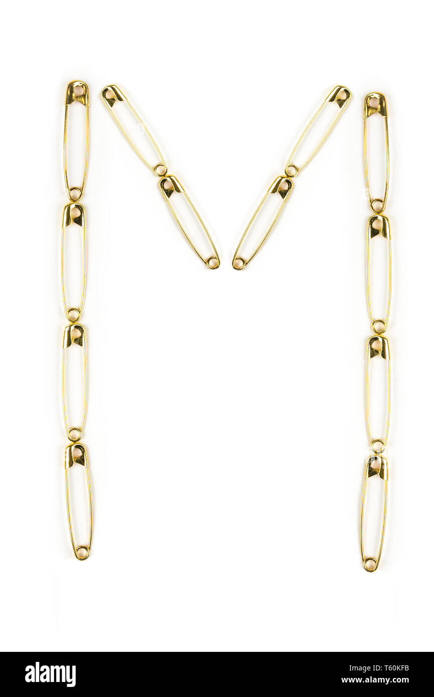 The letter "M" in gold colored safety pins Stock Photo - Alamy