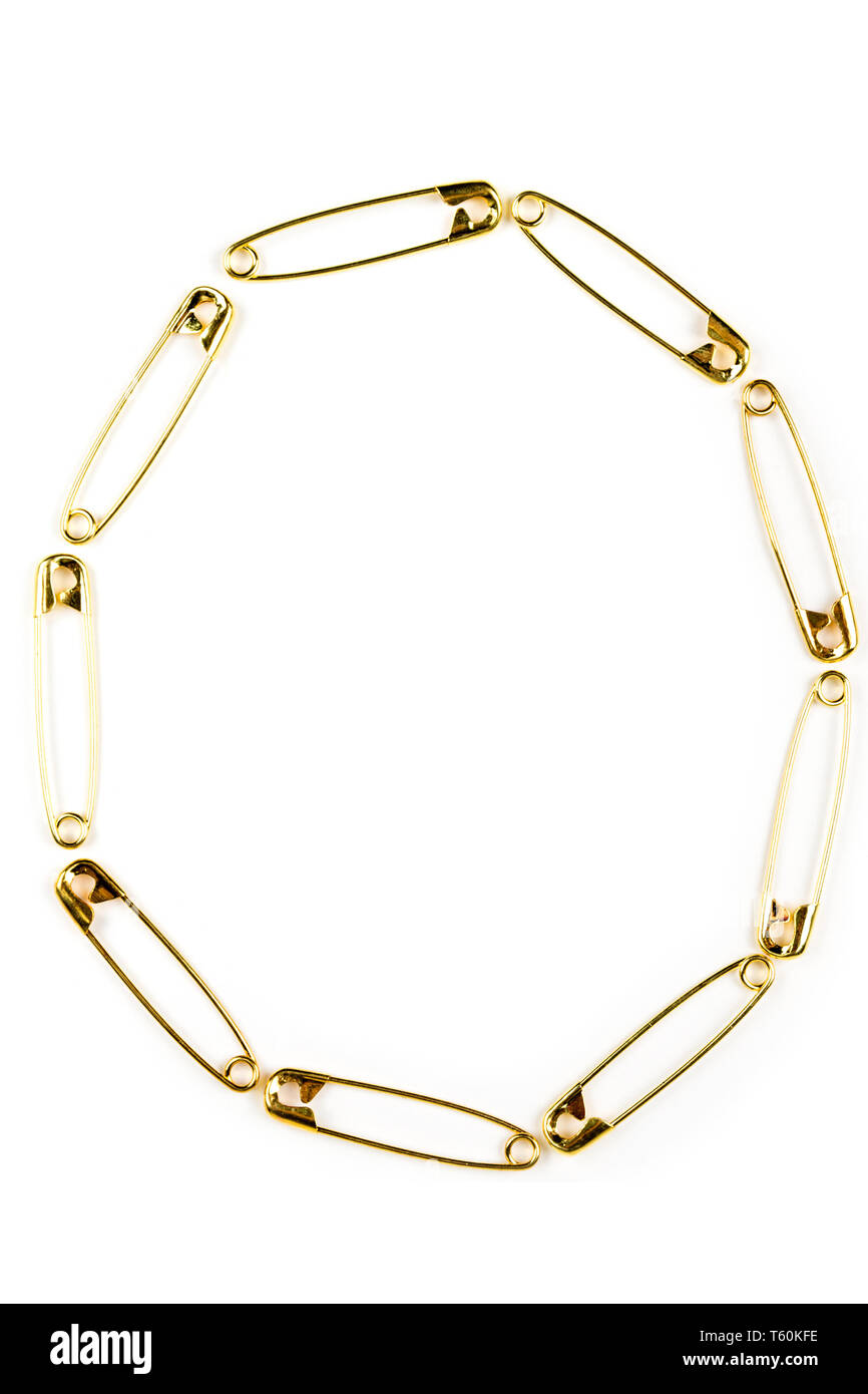 The letter "O" in gold colored safety pins Stock Photo - Alamy