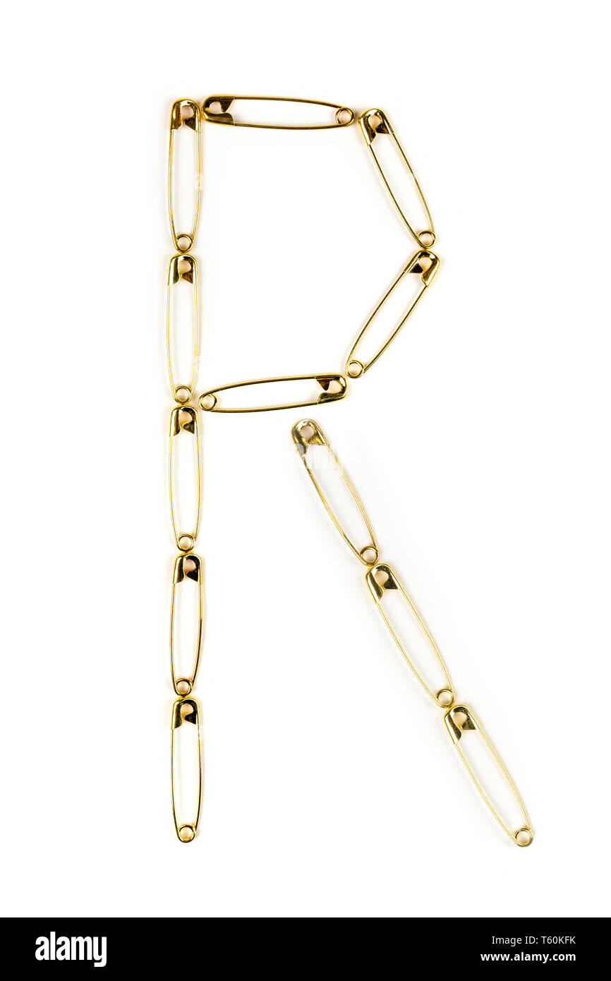 The letter "R" in gold colored safety pins Stock Photo - Alamy