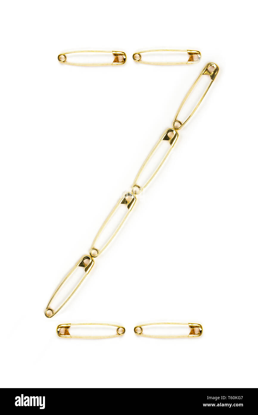 The letter "Z" in gold colored safety pins Stock Photo - Alamy