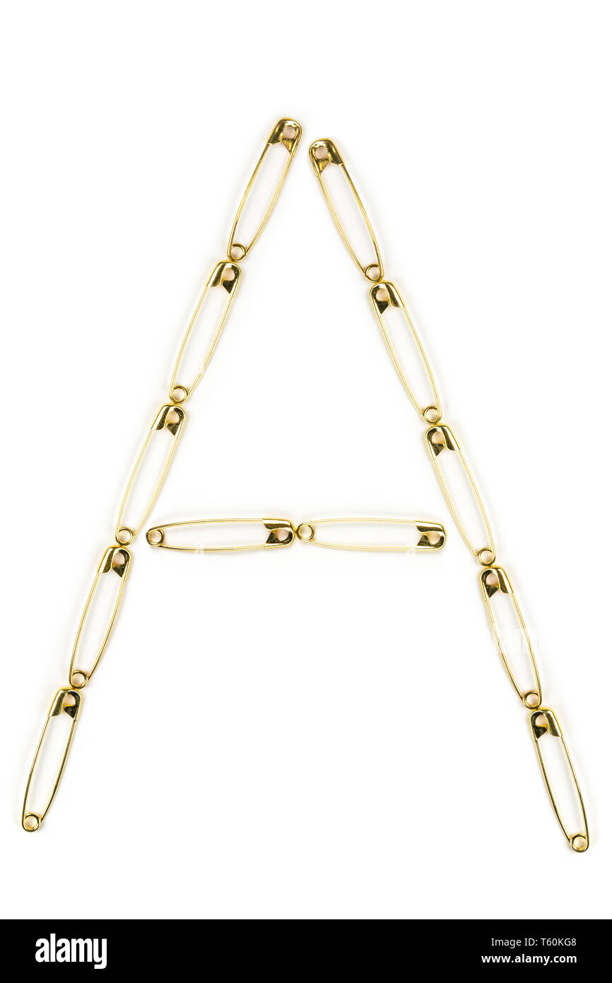 The letter "A" in gold colored safety pins Stock Photo - Alamy