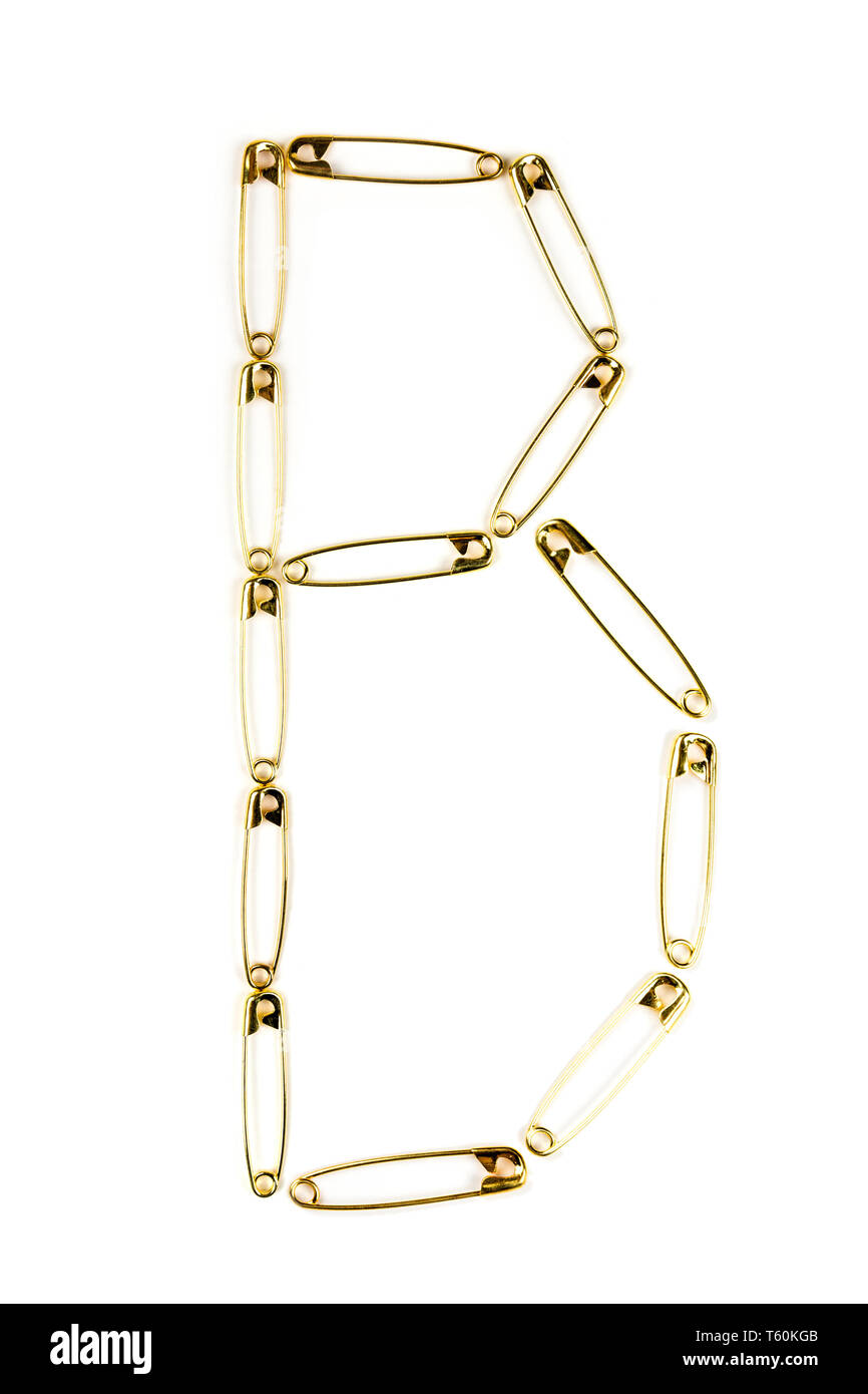 The letter "B" in gold colored safety pins Stock Photo - Alamy