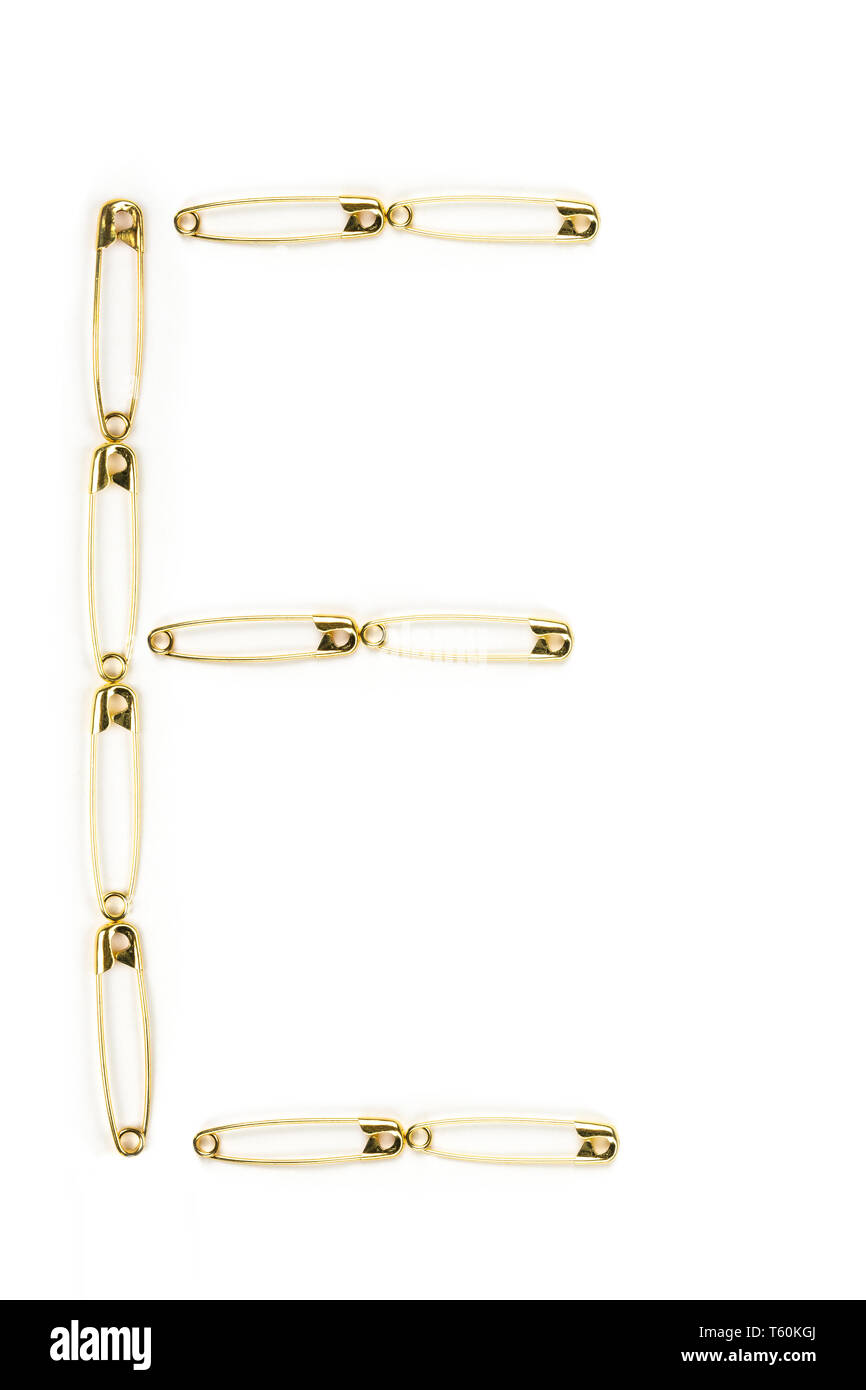 The letter "E" in gold colored safety pins Stock Photo - Alamy