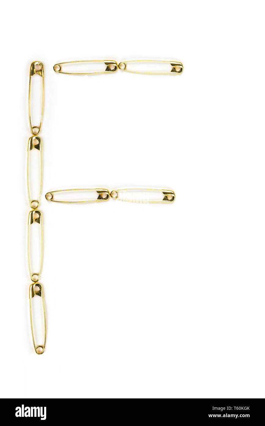 The letter "F" in gold colored safety pins Stock Photo - Alamy