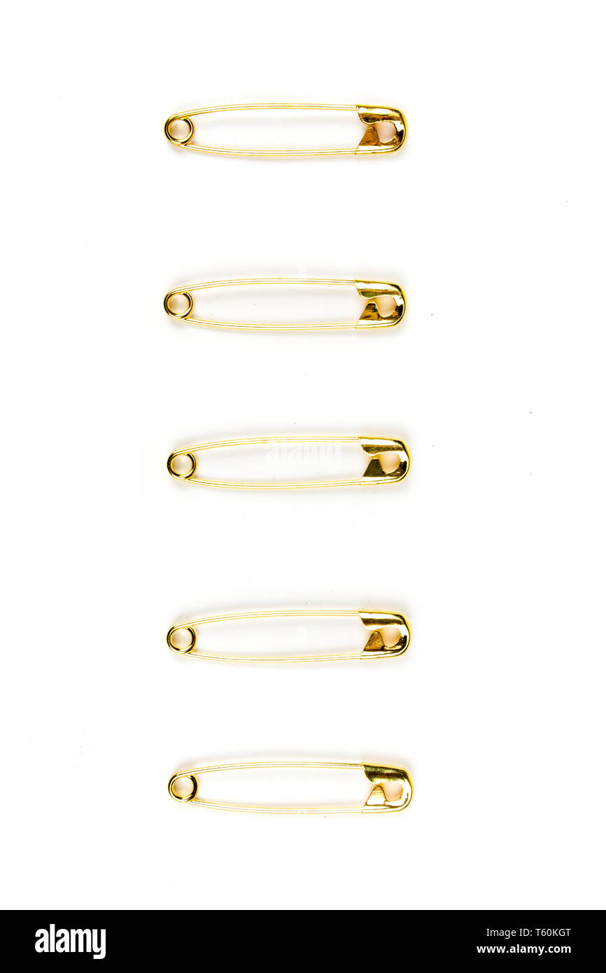 Gold safety pins hi-res stock photography and images - Alamy