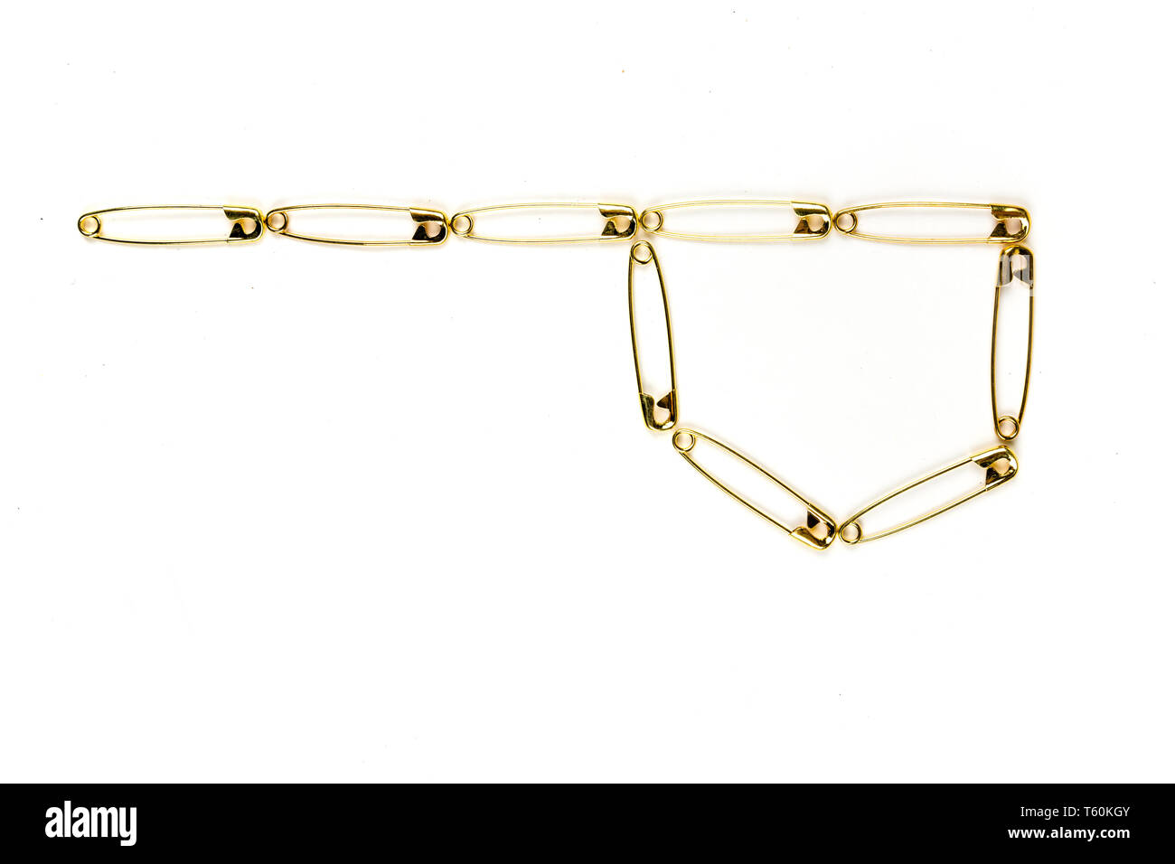 Loops and line shape made of safety pins on a white background Stock ...