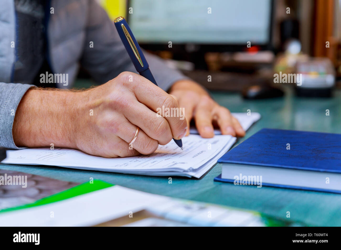 Person completing man hand with pen and business of application form ...