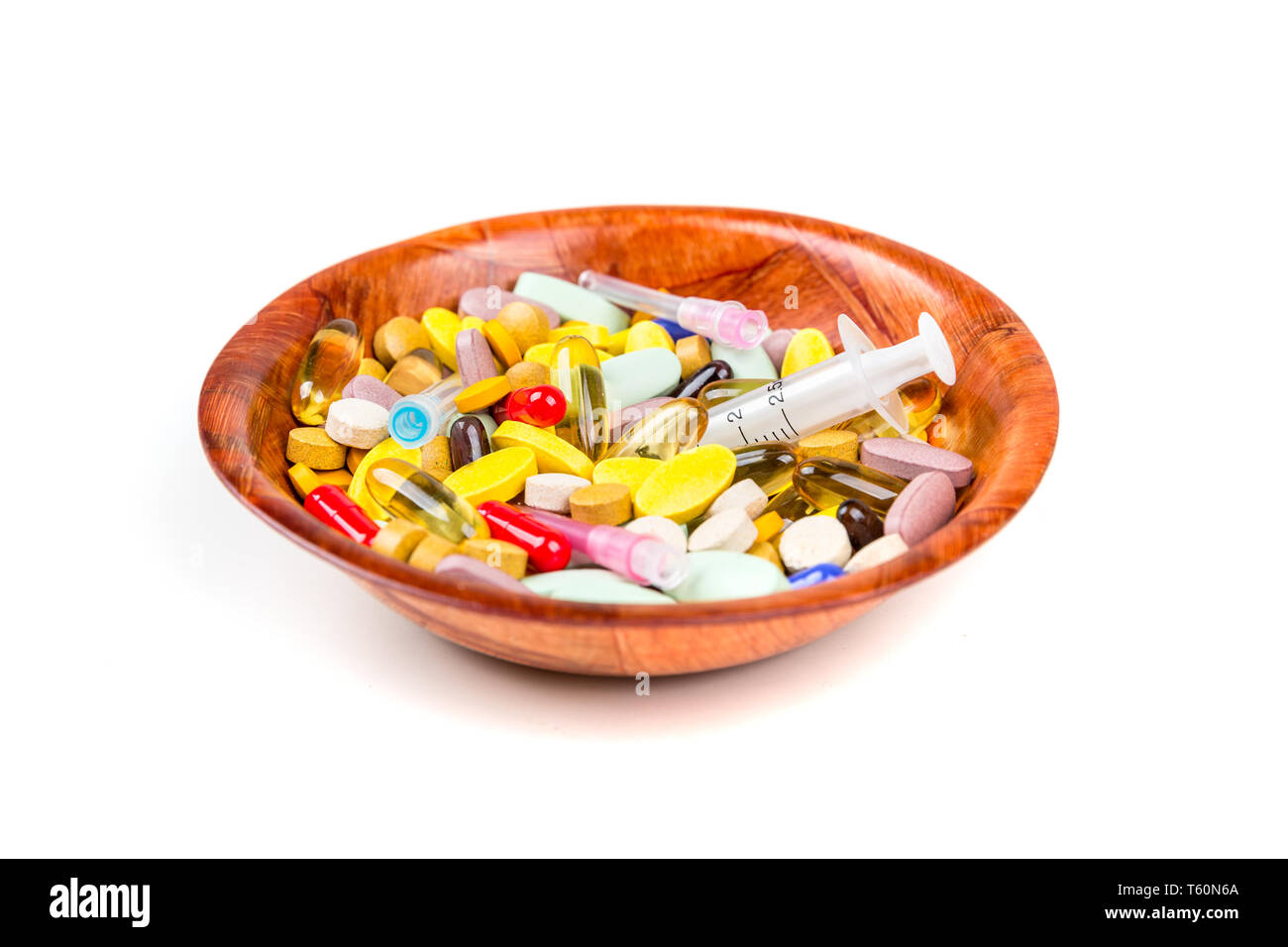 Bowl of multicolored pills and syringes addiction concept Stock Photo ...