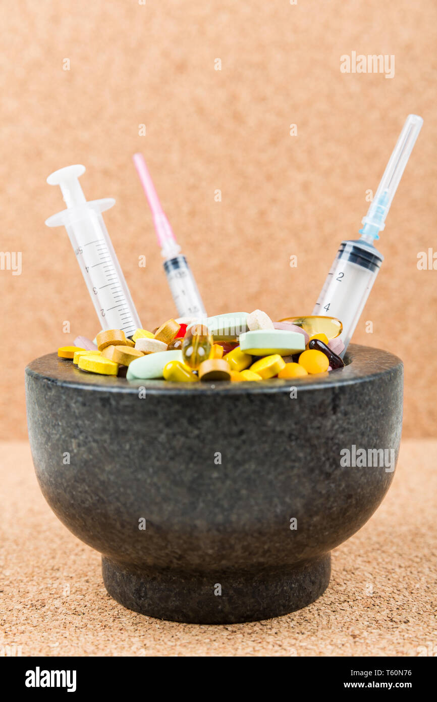 Bowl of multicolored pills and syringes addiction concept Stock Photo ...
