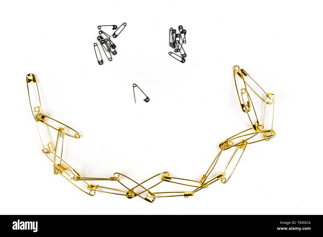 Multicolored safety pins arranged in a smiley face Stock Photo - Alamy