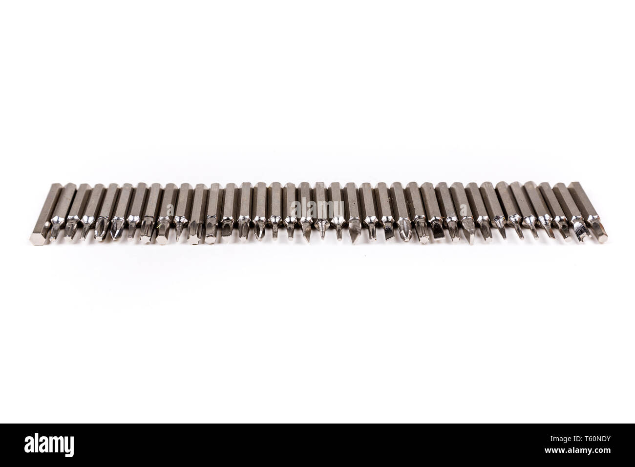 Single line of small metal interchangeable screwdriver bits for a ...
