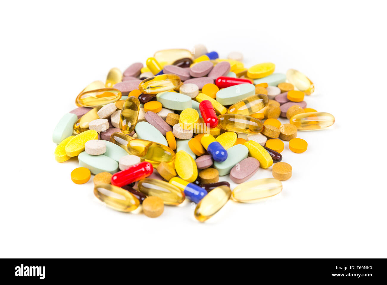 Pile of multicolored pills on a white background Stock Photo - Alamy