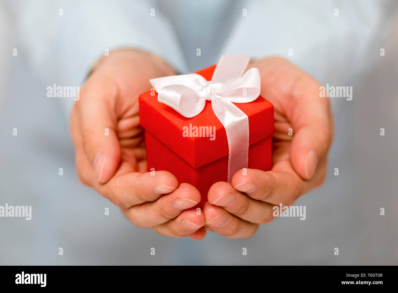 Hand giving present hi-res stock photography and images - Alamy